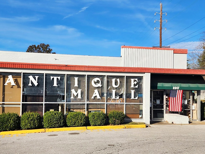 Bold letters spell out "ANTIQUE MALL" at Treasure Isle, where the American flag welcomes patriots and collectors alike.