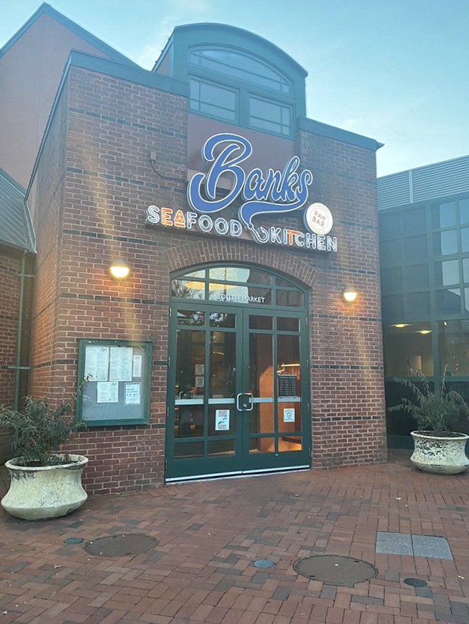 Banks' brick facade glows in the evening light, beckoning seafood lovers to its riverfront tables.
