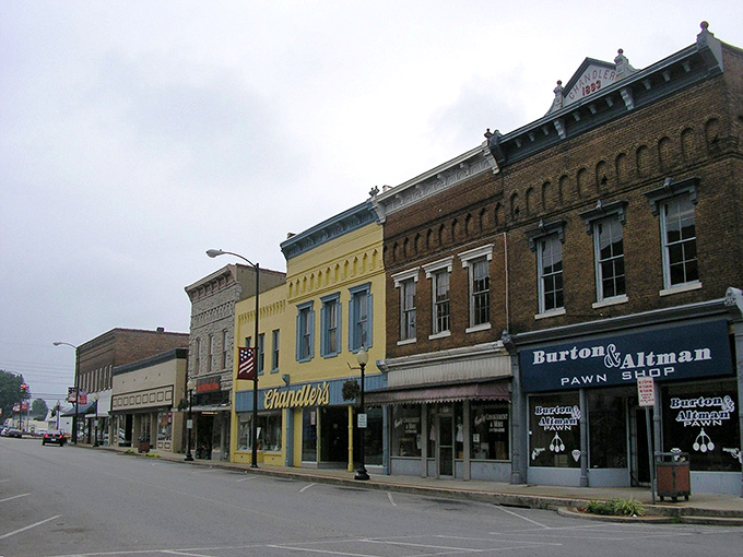 Chandler's bright yellow facade stands out like a friendly hello in Campbellsville's lineup. Small-town architecture with big personality!