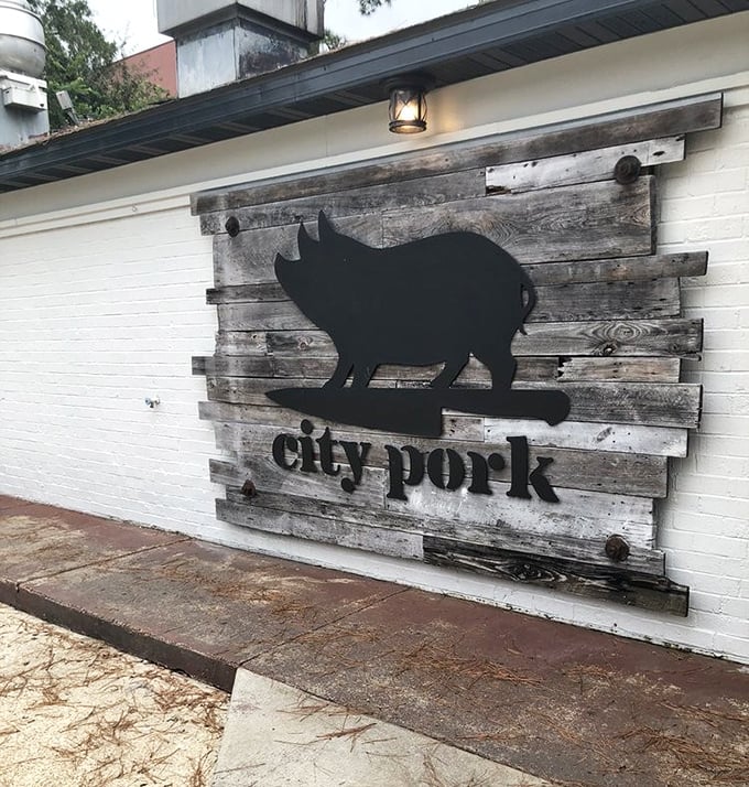 Those red roses framing the rustic sign create the perfect contrast &ndash; much like how their sauce complements their perfectly smoked meats.