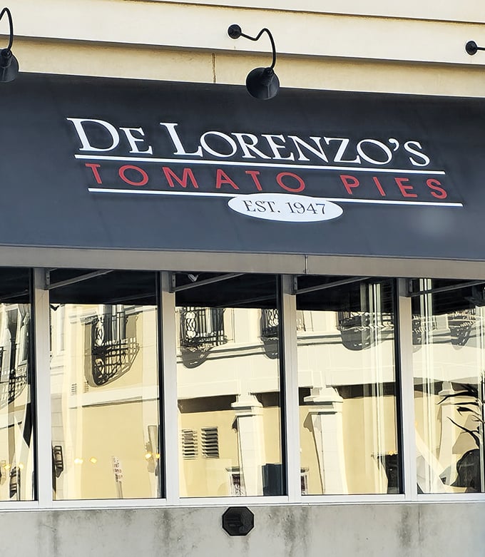Morning light reveals De Lorenzo's understated elegance. Behind those windows, tomato pie perfection awaits the patient pizza lover.