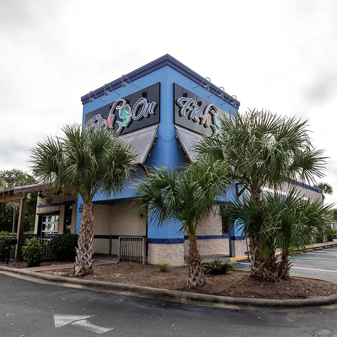 Palm trees frame this blue beacon of seafood excellence. Fish On's distinctive building stands out like a delicious landmark in Destin.