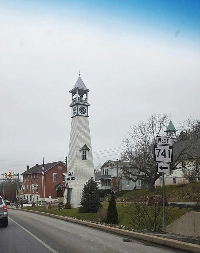 That white church tower stands proud like a lighthouse guiding travelers through this peaceful rural landscape.