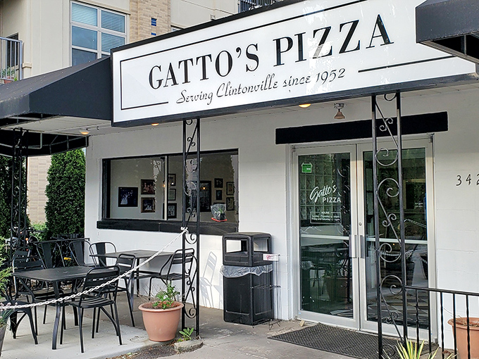 Outdoor tables invite lingering conversations over slices that make every bite worth savoring slowly.