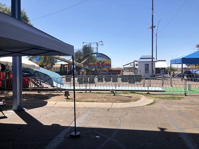 Carnival meets commerce! Beyond Greyhound's blue fence, colorful rides spin under perfect Arizona skies&mdash;because nothing works up an appetite for bargain hunting like a whirl on the teacups.