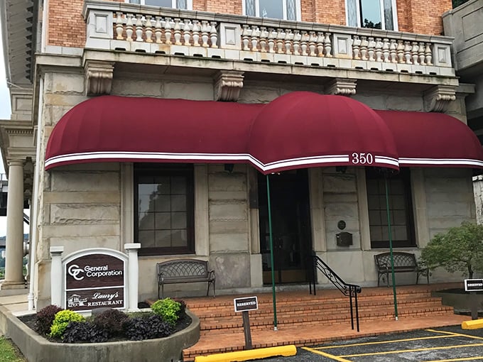 That elegant red canopy marks the entrance to Laury's, where Charleston's history meets contemporary cuisine in a riverside setting.