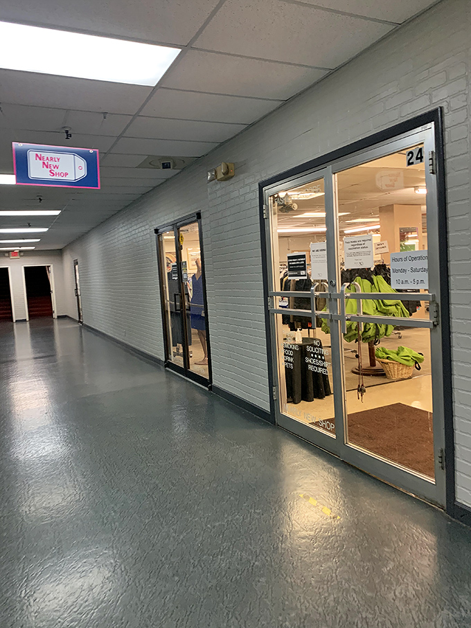 The Nearly New Shop sign glows like a beacon for the bargain-savvy. Those pristine display windows hint at the boutique-quality finds inside.
