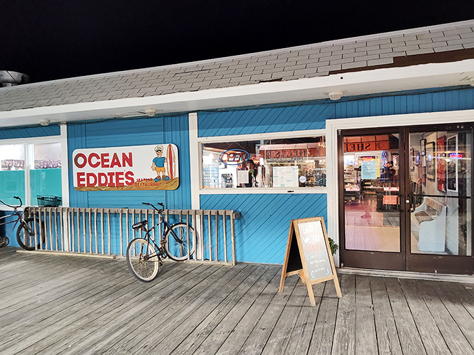 Night falls but Ocean Eddie's keeps the seafood flowing, with its neon glow beckoning hungry beach wanderers.