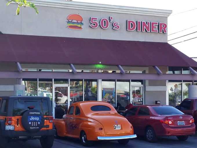 That classic orange hot rod parked outside the 50's Diner isn't just transportation – it's the perfect appetizer for what awaits inside.