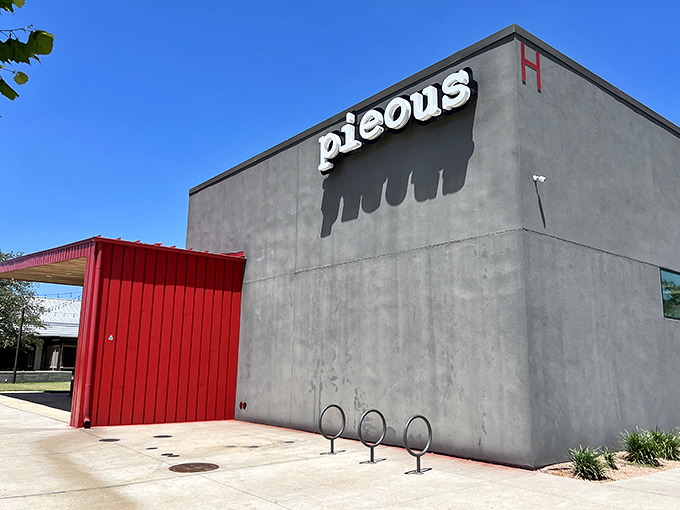 The stark gray exterior of Pieous hides Austin's sourdough pizza revolution. Minimalist outside, maximalist flavors inside.