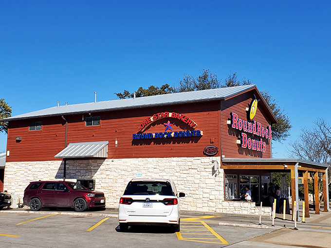 The wooden and stone exterior of Round Rock Donuts looks like it was built to withstand both Texas heat and the stampede of hungry customers.