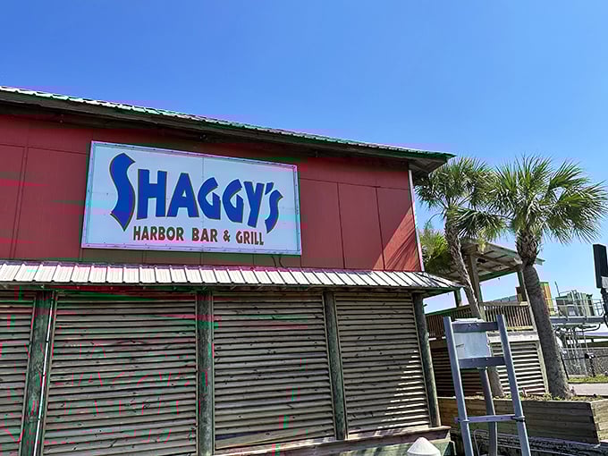 The bright blue sign on the deck promises outdoor dining with water views and maybe even a pelican or two as dinner guests.