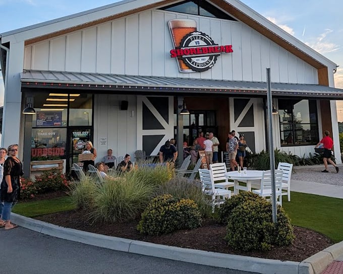 The white tables and coastal landscaping at Shorebreak create the perfect backdrop for pizza that's anything but background noise.