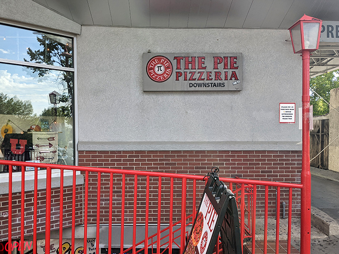 That downstairs entrance leads to pizza legend - where enormous slices become local folklore tales.