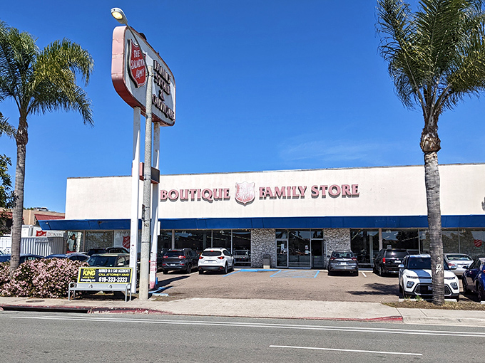 The San Diego Salvation Army store announces itself with a cheerful "We're Open" sign. Behind that fence lies a treasure trove of second-hand delights.