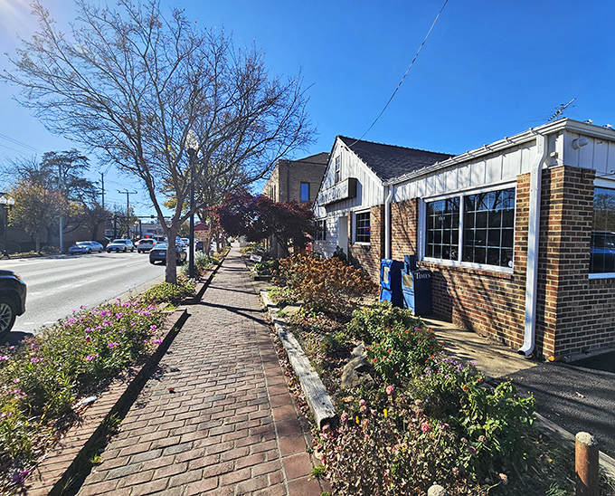 Brick pathways and flower beds welcome you to this cozy spot where hot dogs are elevated to an art form.