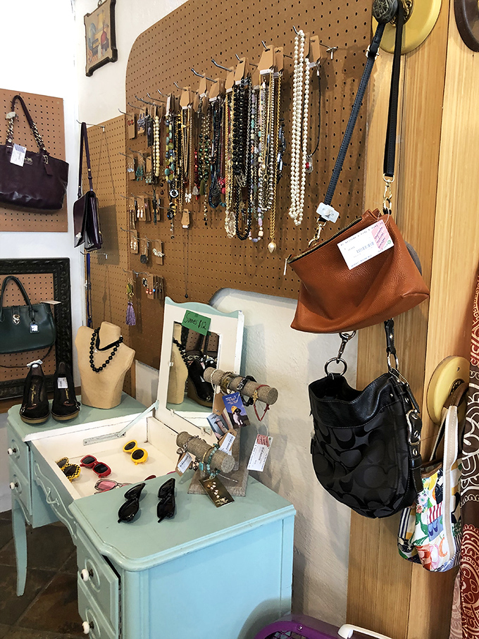 Jewelry and handbags displayed with care. Each necklace and purse waits patiently for its second chance at making a fashion statement.