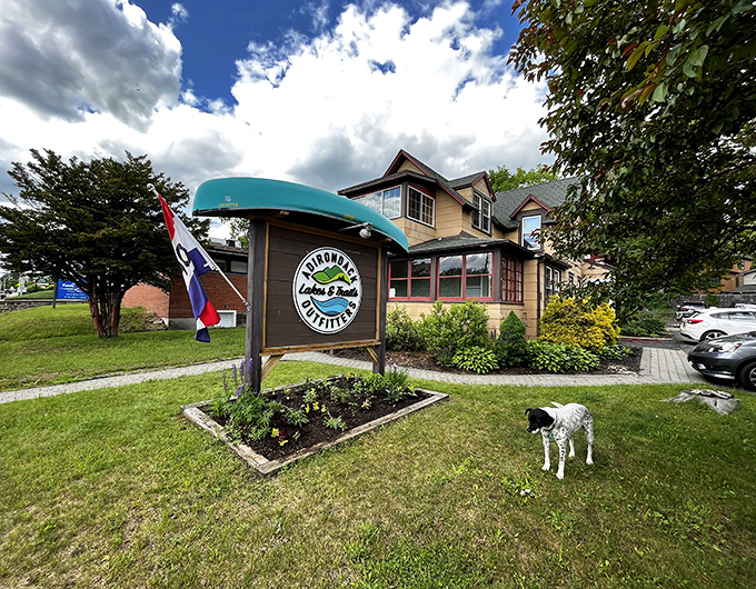 Adirondack Lakes & Trails Outfitters stands ready with everything you need for adventure, plus a canine greeter who's clearly employee of the month.
