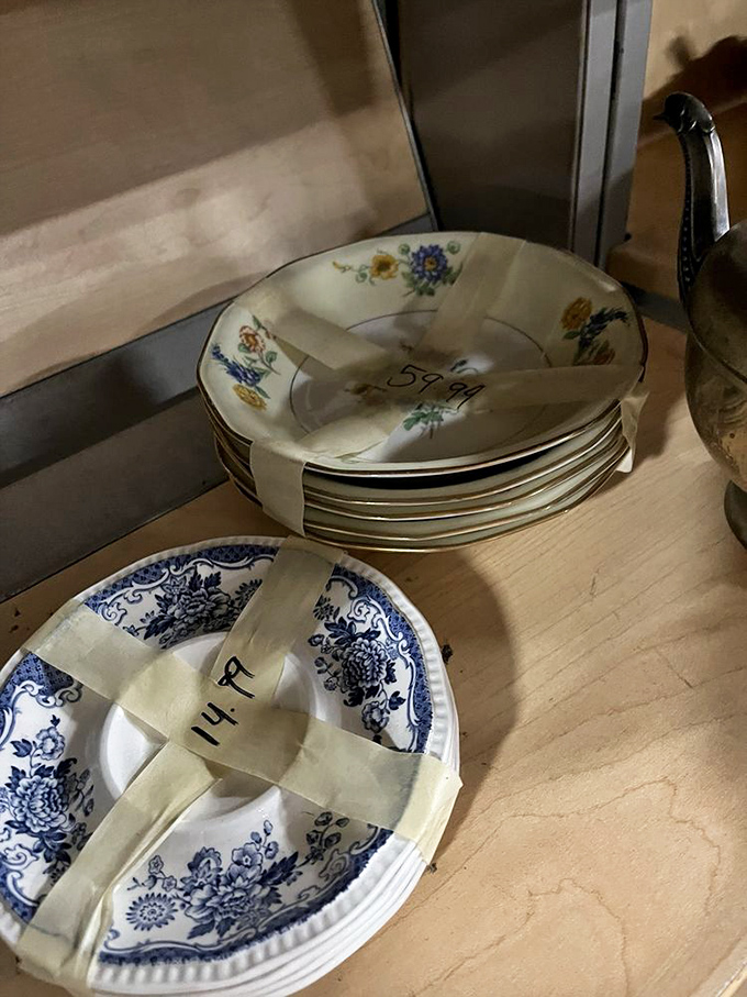 Delicate china plates bundled with care, their floral and blue patterns whispering tales of family dinners past. Grandma would approve of these vintage table settings.