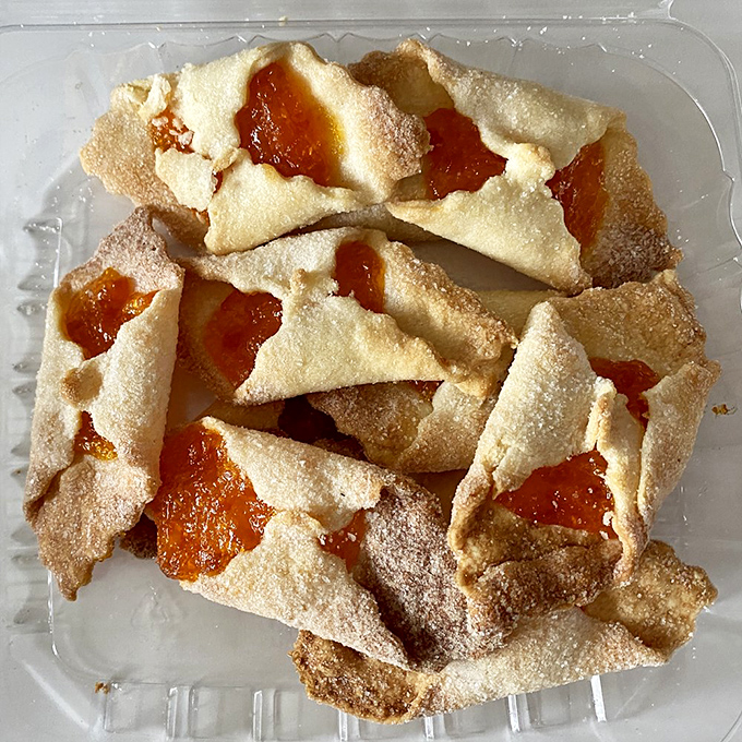 Delicate kolaczki cookies with sweet fruit filling peeking through like little windows to paradise. One is never enough, trust me on this.