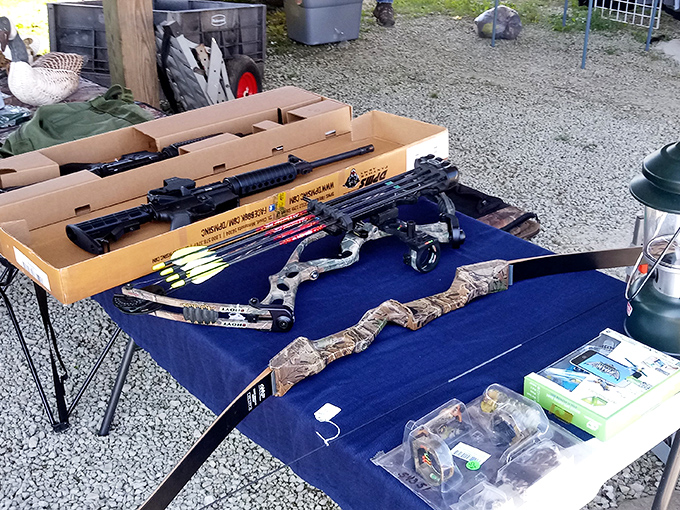 Archery equipment laid out on patriotic fabric&mdash;because nothing says weekend warrior quite like a compound bow purchase.