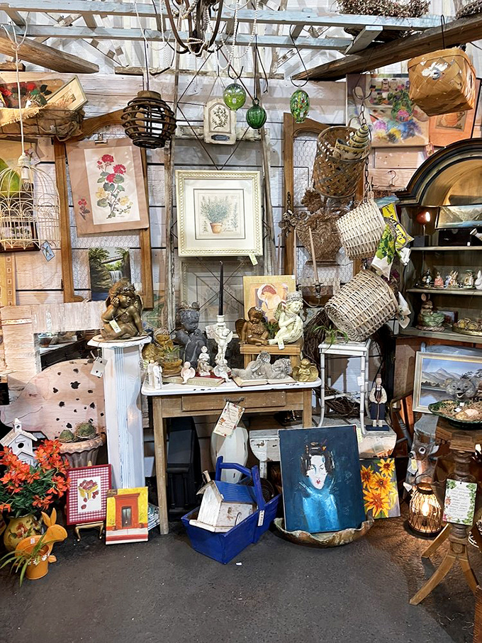 Every inch of wall and shelf space tells a story in this booth, where vintage baskets hang alongside framed artwork in organized chaos.