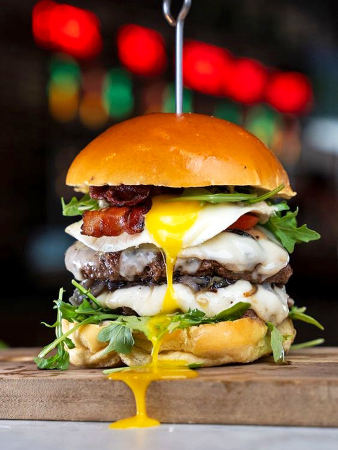 This towering achievement of burger engineering features a runny egg that's basically saying, "Go ahead, get messy &ndash; the best meals require extra napkins."