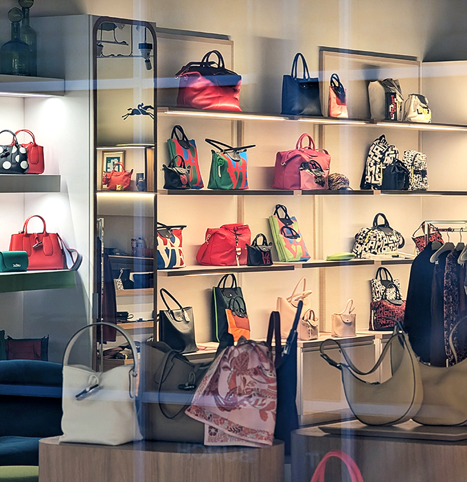 Handbag heaven arranged like a museum of affordable luxury. Each shelf tells a story of "I can't believe I got this for that price!"