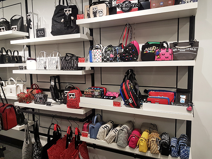 Designer handbags lined up like contestants in a beauty pageant, each one silently whispering, "Pick me, I'll make your outfit complete."