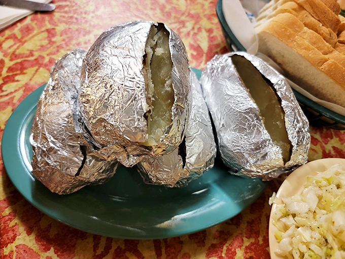 Foil-wrapped baked potatoes, like little silver presents waiting to be unwrapped, reveal simple pleasures inside.