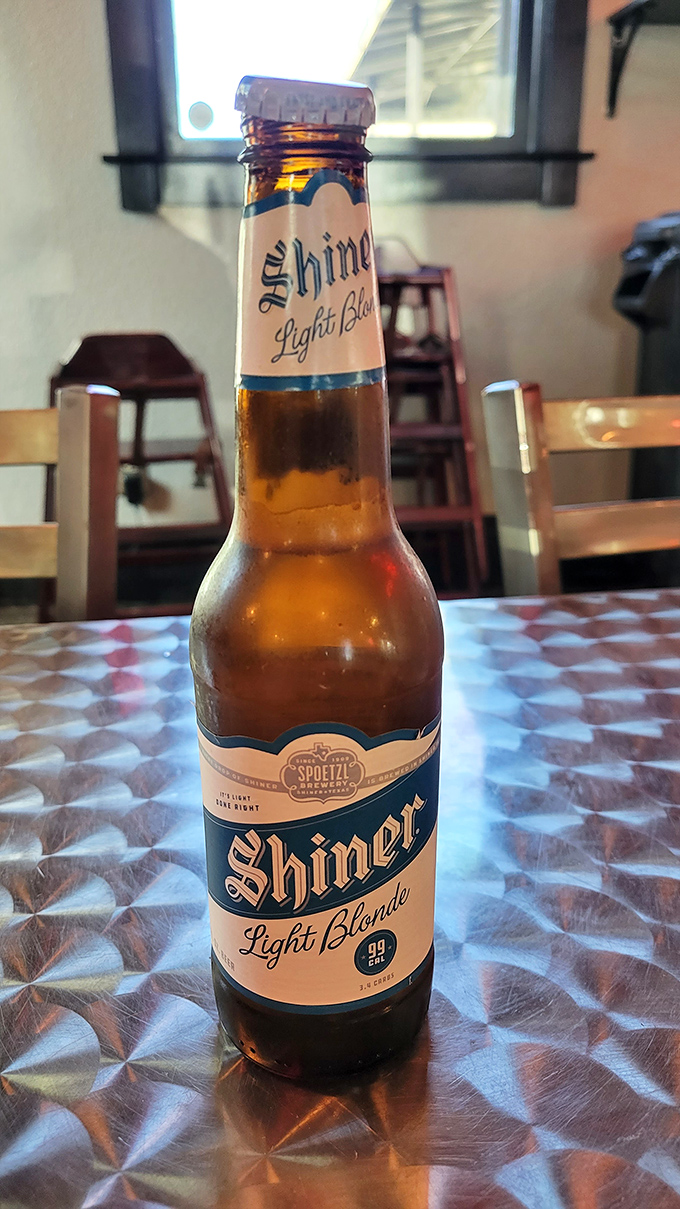 A Shiner Blonde &ndash; Texas' liquid ambassador &ndash; standing at attention on the classic red-checkered tablecloth. The perfect palate cleanser.