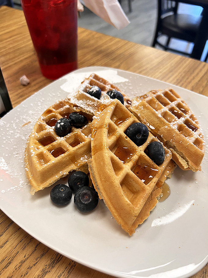 Belgian waffles with fresh blueberries and a dusting of powdered sugar &ndash; breakfast that doubles as dessert without a hint of guilt.