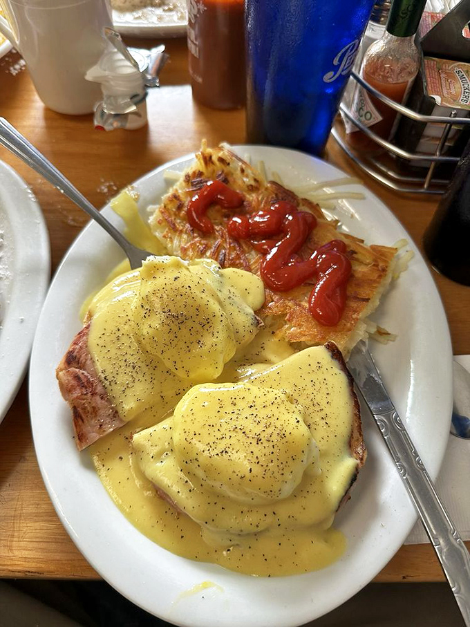 Eggs Benedict with a hollandaise so yellow it could outshine the California sun. The hash browns with ketchup add that perfect touch of diner authenticity.