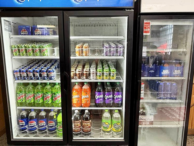 The beverage cooler&mdash;where your pizza's perfect partner awaits. From Pepsi to Mountain Dew, it's a nostalgic lineup of fizzy companions.