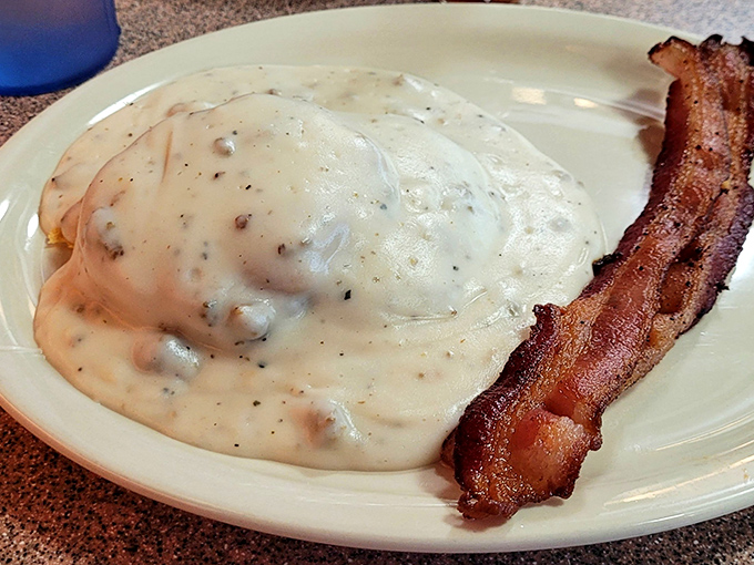 Biscuits and gravy&mdash;the breakfast that hugs you from the inside. That crispy bacon standing at attention is just showing off.