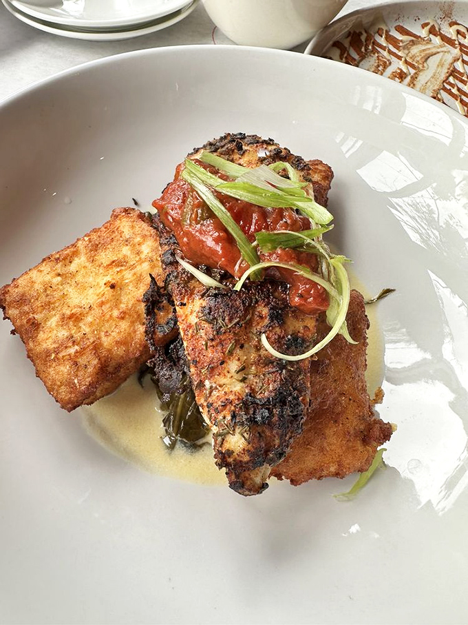 Blackened catfish with a side of cornbread—proof that sometimes the best ocean-mountain romance happens right on your plate.