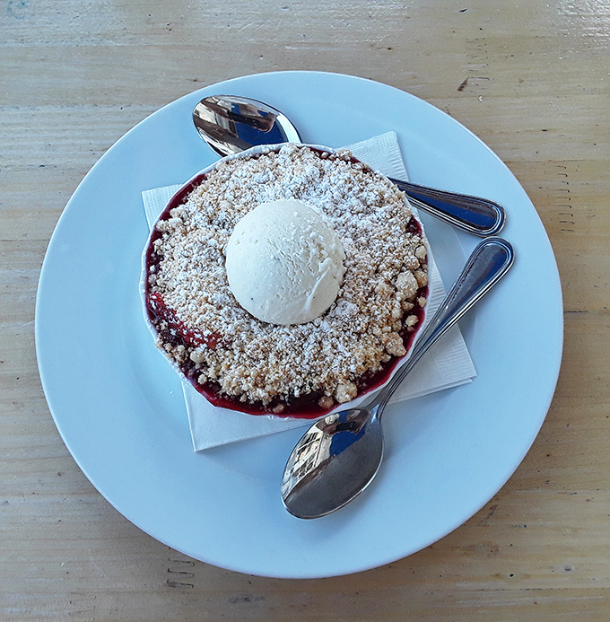 This blueberry cobbler isn't just dessert; it's summer captured in a skillet, crowned with ice cream slowly surrendering to the warm fruit below.