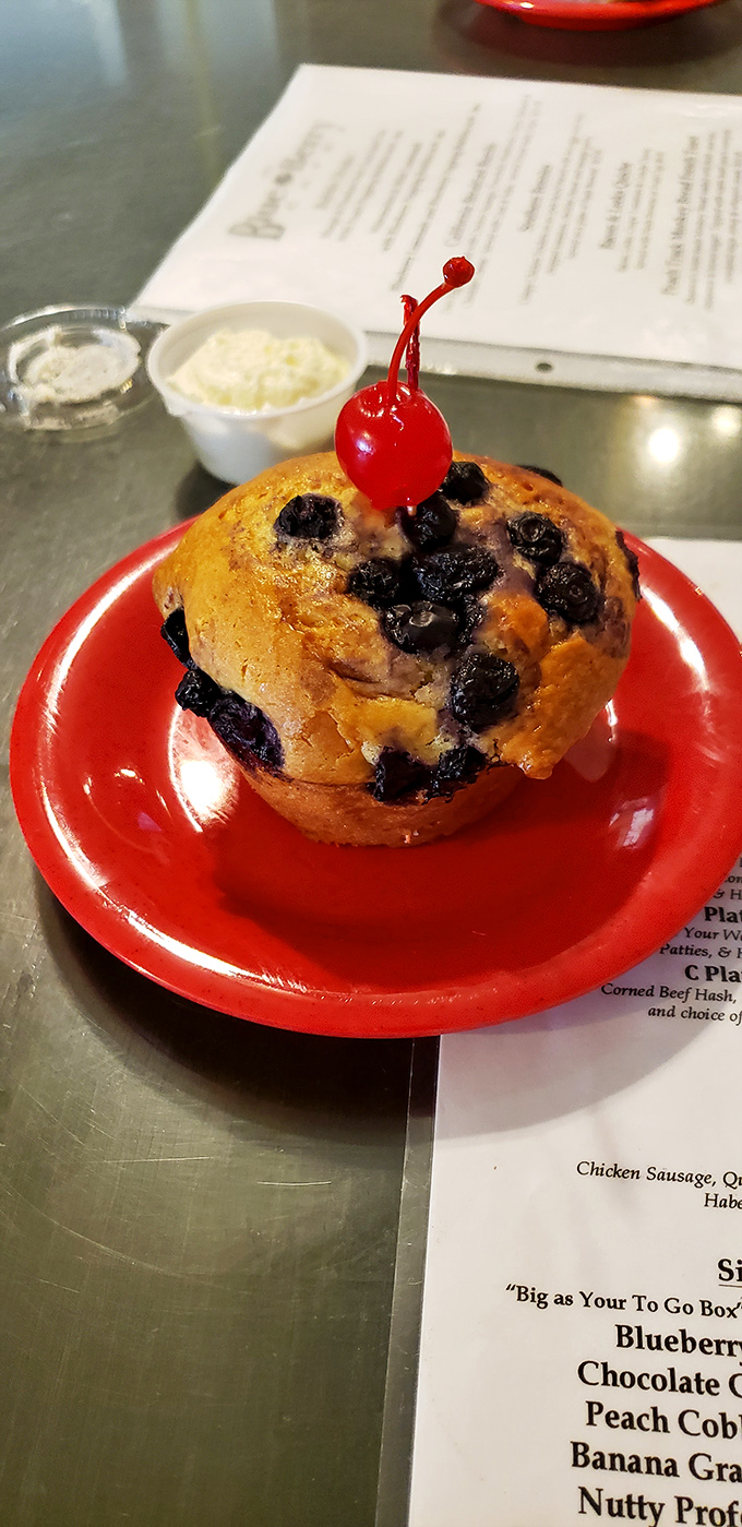This blueberry muffin, crowned with a cherry sentinel, isn't just breakfast&mdash;it's a morning celebration that makes Monday feel like Saturday.