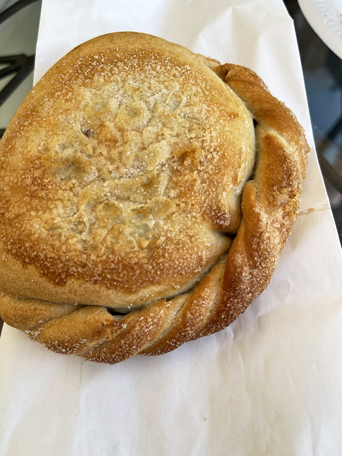 The crimped edge of this pasty barely contains its sweet secret. Blueberry filling peeks out, promising a dessert experience worth the drive north.