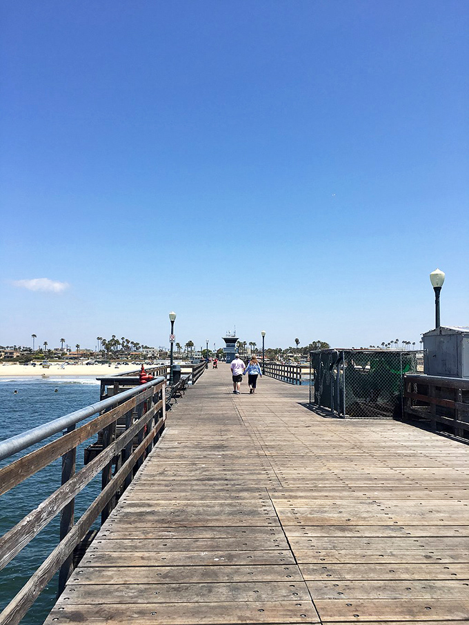 The wooden planks of Seal Beach Pier have supported generations of dreamers, fishermen, and sunset-chasers seeking their moment of Pacific magic.