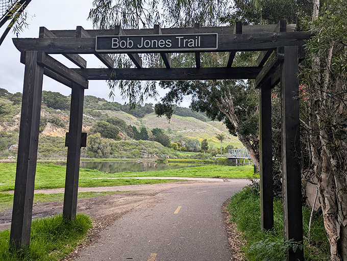 The Bob Jones Trail entrance stands as a wooden gateway to adventure, inviting cyclists and hikers to explore the scenic path ahead.