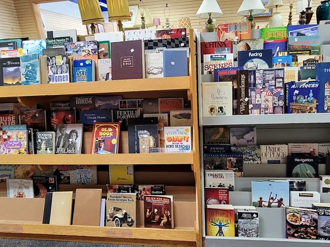 Books stacked like literary Jenga, where Danielle Steel meets Stephen King in paperback paradise.