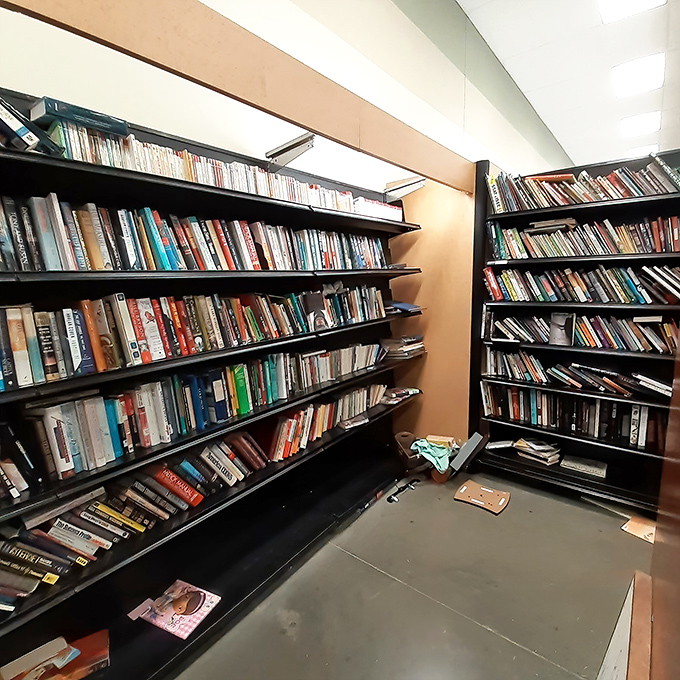 The book corner feels like a library where every volume costs less than a fancy coffee—literary treasures stacked floor to ceiling for voracious readers.