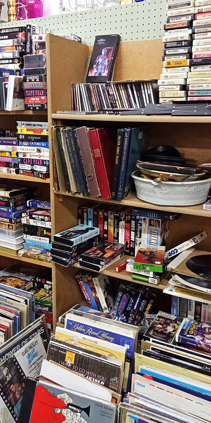 A media lover's paradise where VHS tapes, vinyl records, and forgotten paperbacks create a time tunnel to entertainment past. Spot any favorites from your youth?