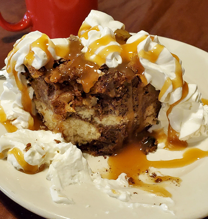 This isn't just dessert—it's an architectural marvel of cake, whipped cream, and caramel that makes you question why you ever wasted stomach space on vegetables.