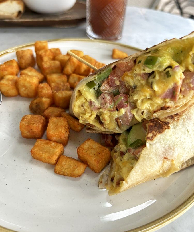 When a breakfast burrito is cut this perfectly, revealing its treasure of eggs, ham, and avocado, resistance is simply futile.