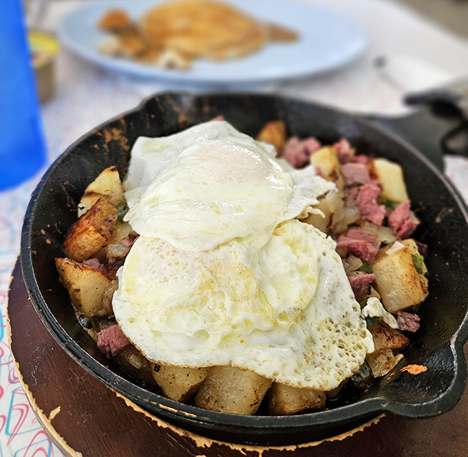 Cast iron skillets arrive sizzling with enough breakfast goodness to fuel your entire Savannah adventure.