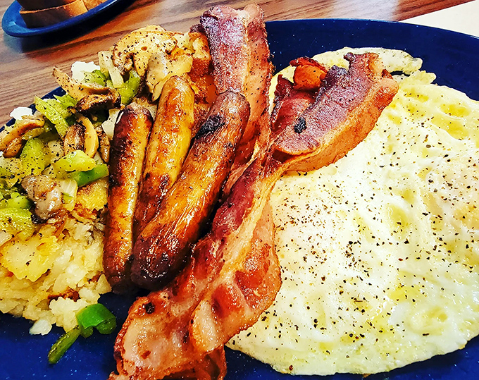 The breakfast trinity&mdash;crispy bacon, golden eggs, and home fries&mdash;proof that sometimes the simplest combinations are culinary perfection.