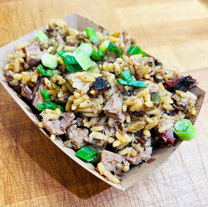 Brisket dirty rice &ndash; where Texas smoke meets Louisiana soul in a cardboard boat that should be enshrined in a food museum.