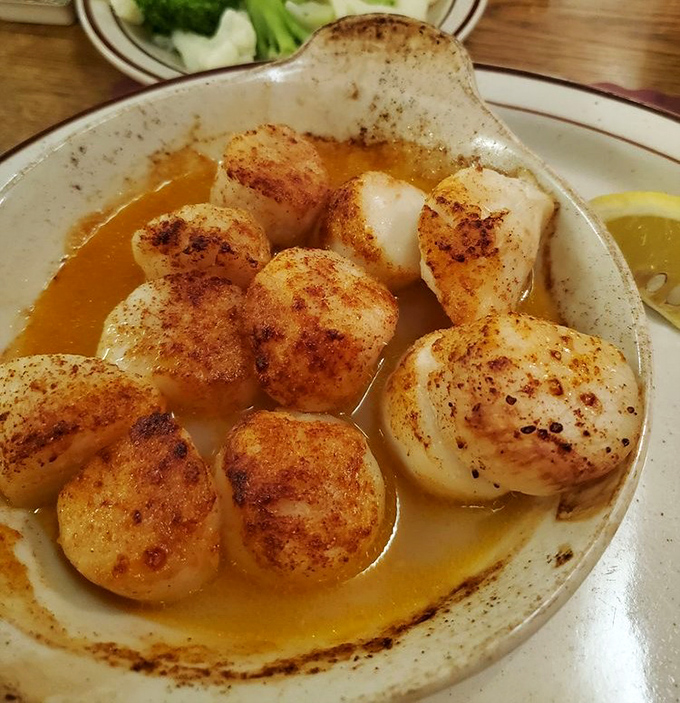 Broiled scallops swimming in butter sauce&mdash;where each perfectly caramelized morsel delivers that sweet ocean flavor that makes you momentarily forget you're in Ohio.